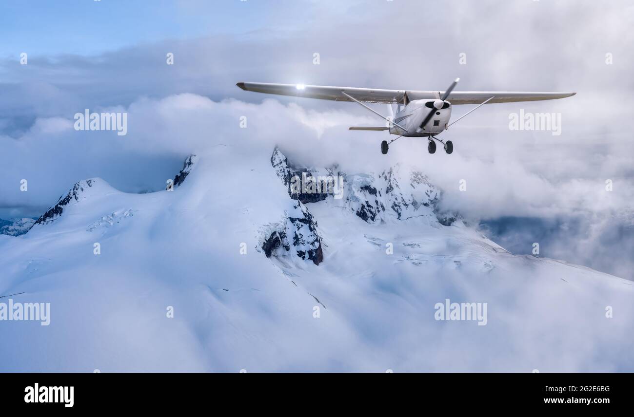Airplane flying near the Beautiful Canadian Mountain Nature Landscape ...