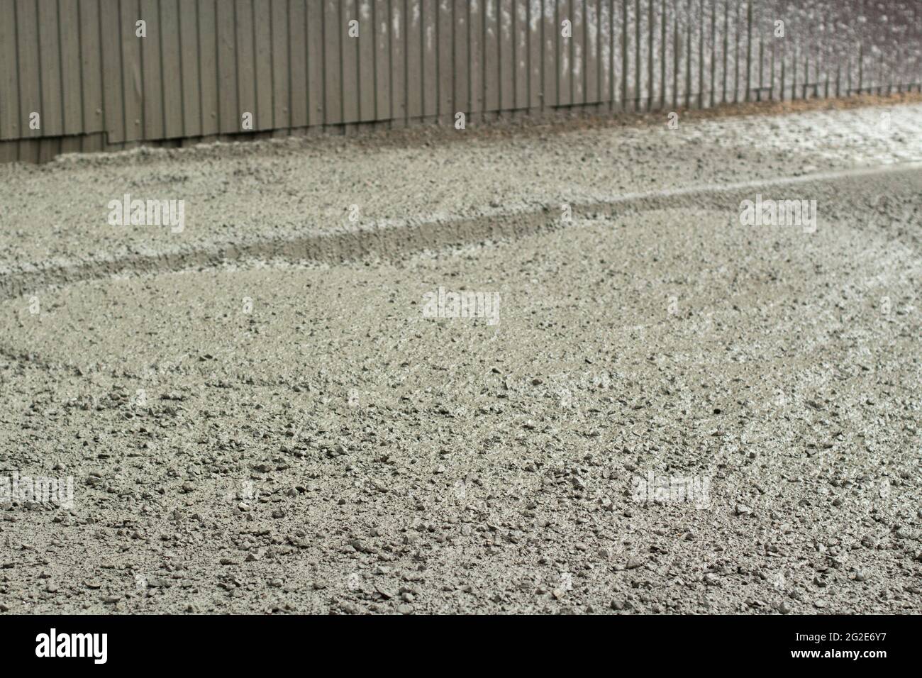 Liquid cement at a construction site. Cement spilled onto the road. The ...