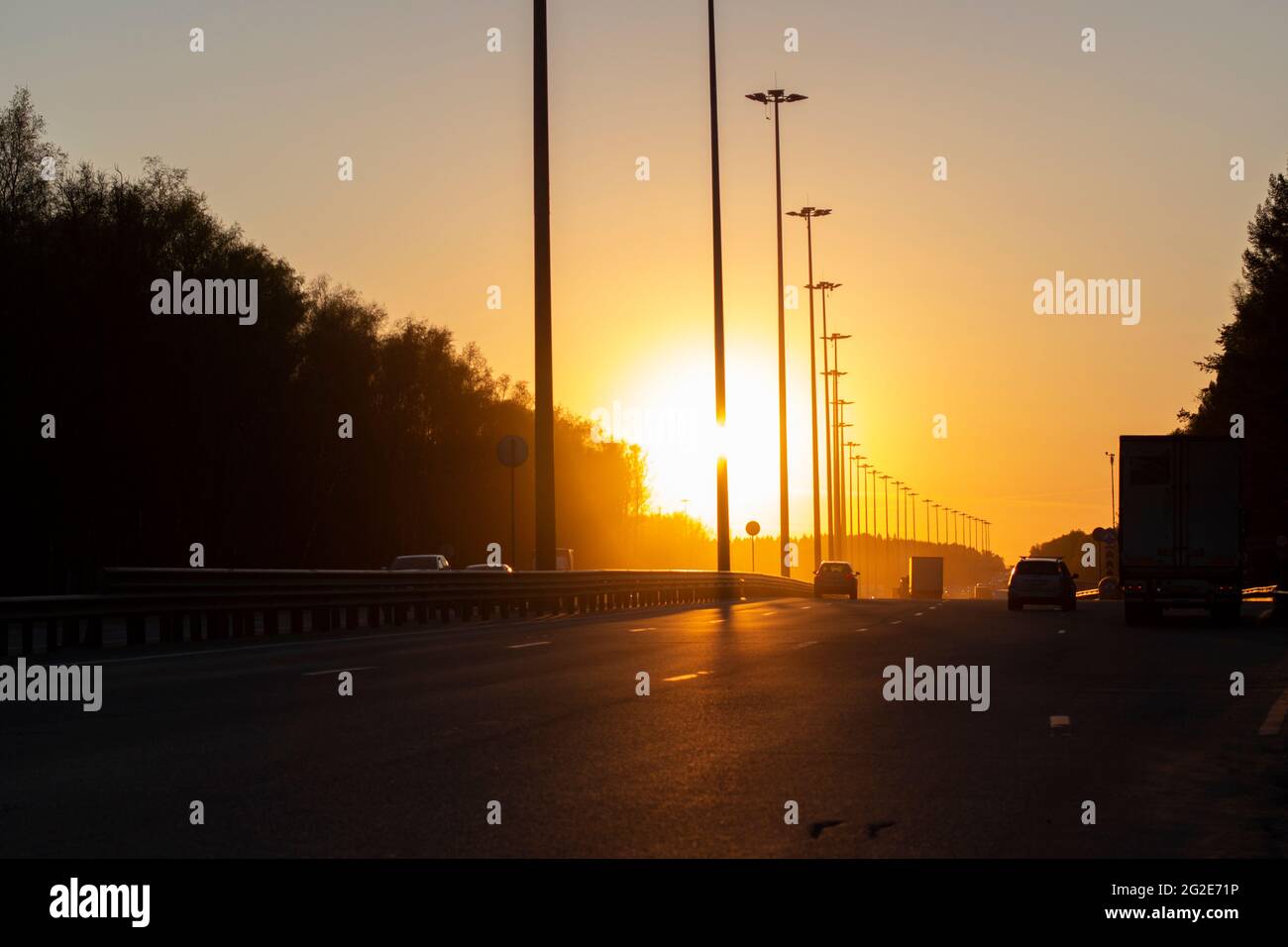 Sunset on the highway. The sun is setting over the highway. Loaded ...
