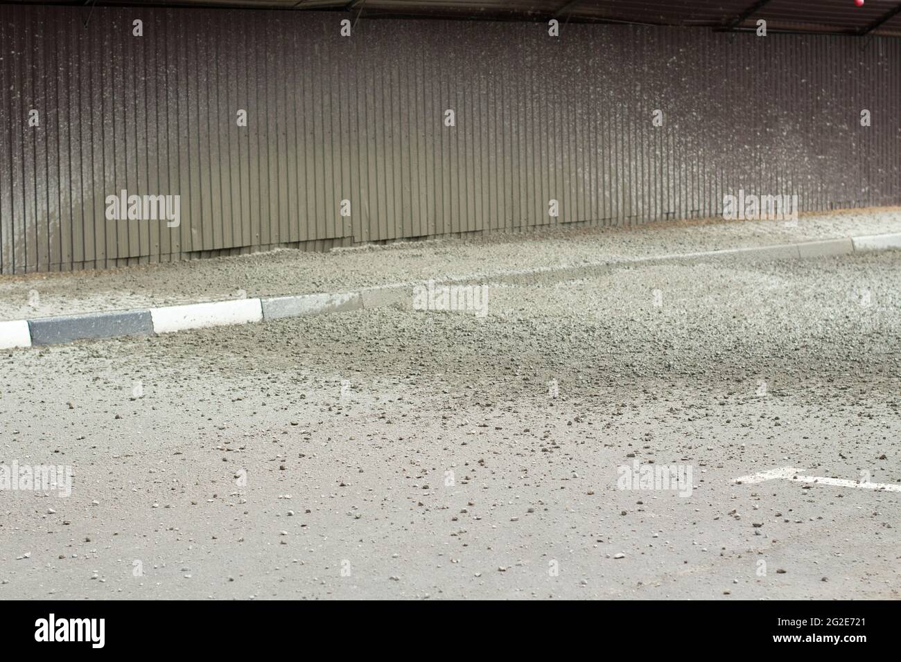 Liquid cement at a construction site. Cement spilled onto the road. The ...