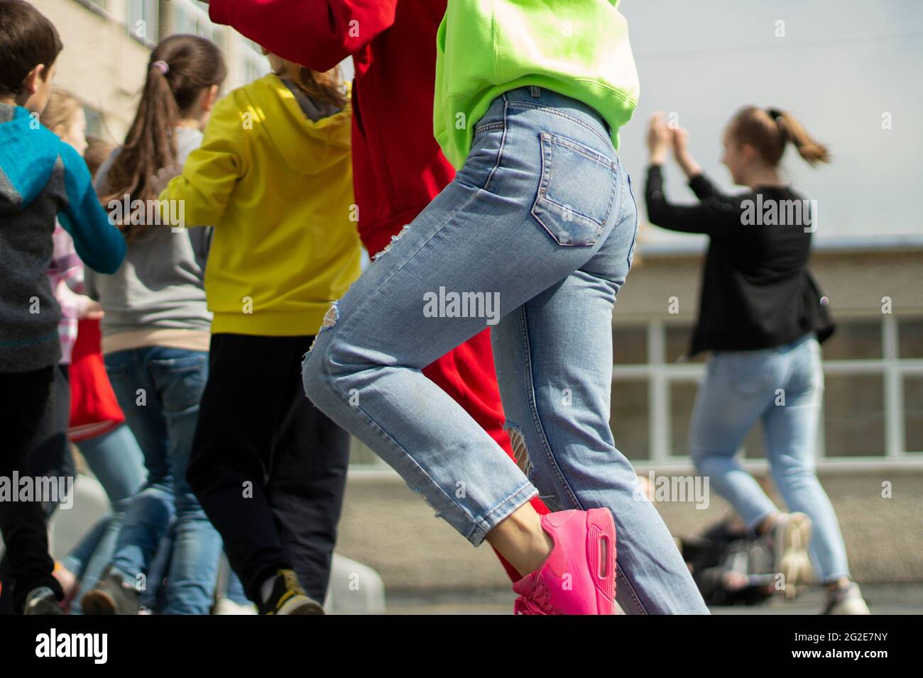 Children are dancing in the street. Many children dance to the music in ...