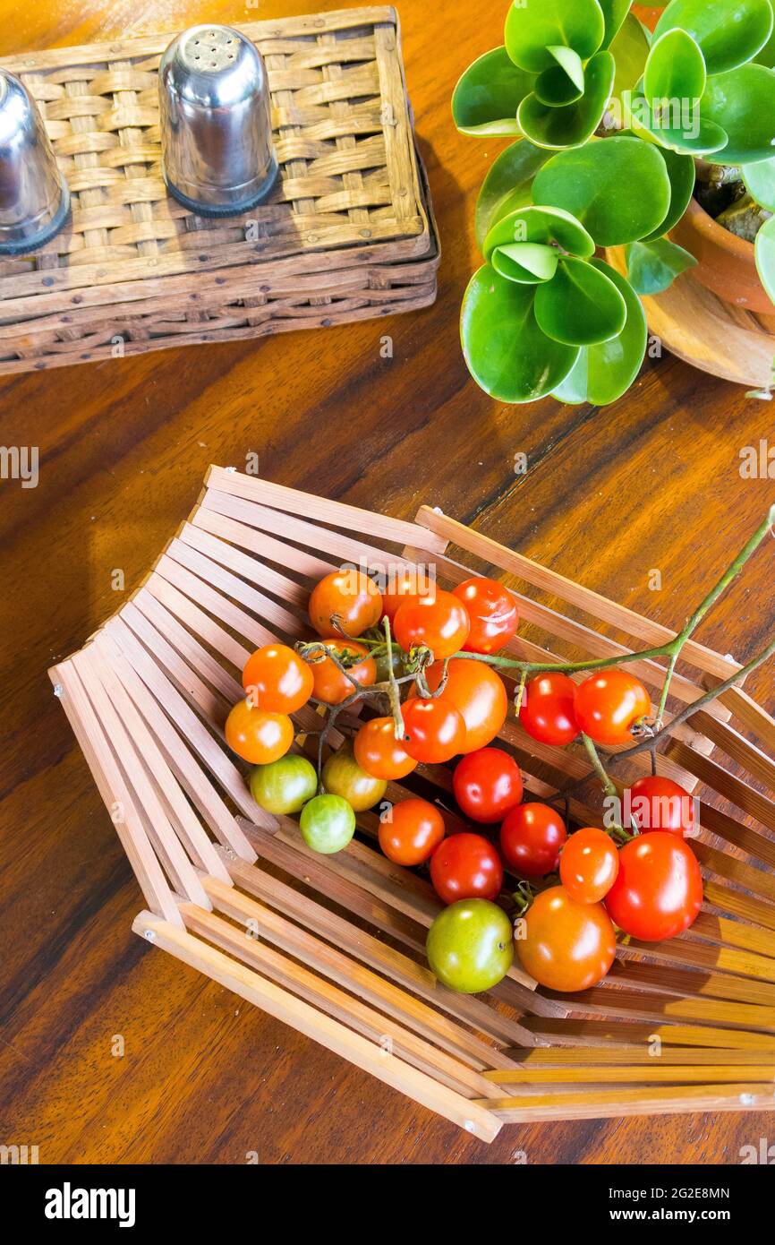 Wooden tray with cherry tomatoes; ingredient for food preparation Stock ...