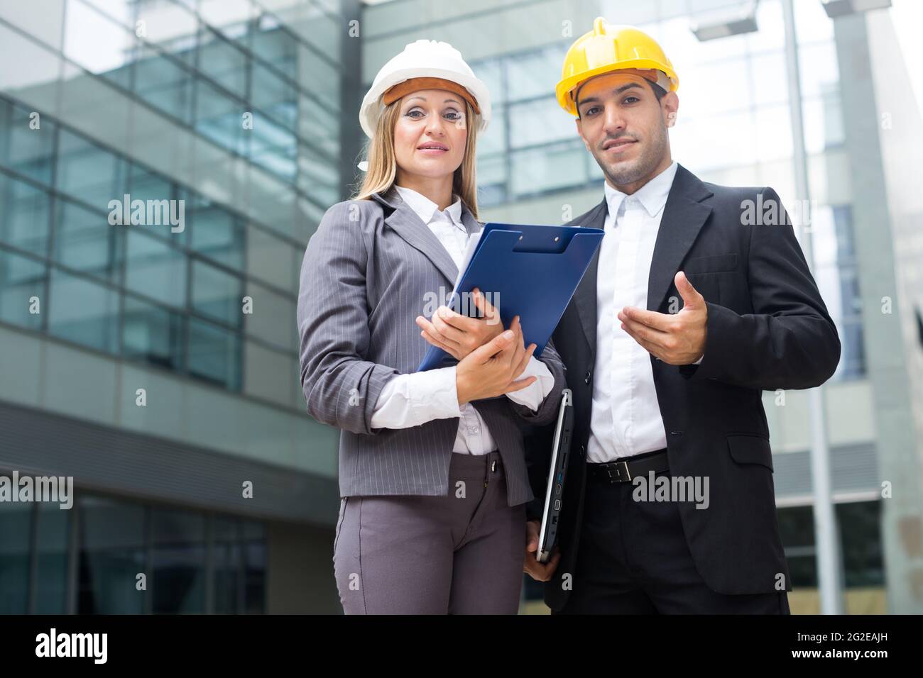 Engineer and woman designer are standing with folder Stock Photo - Alamy