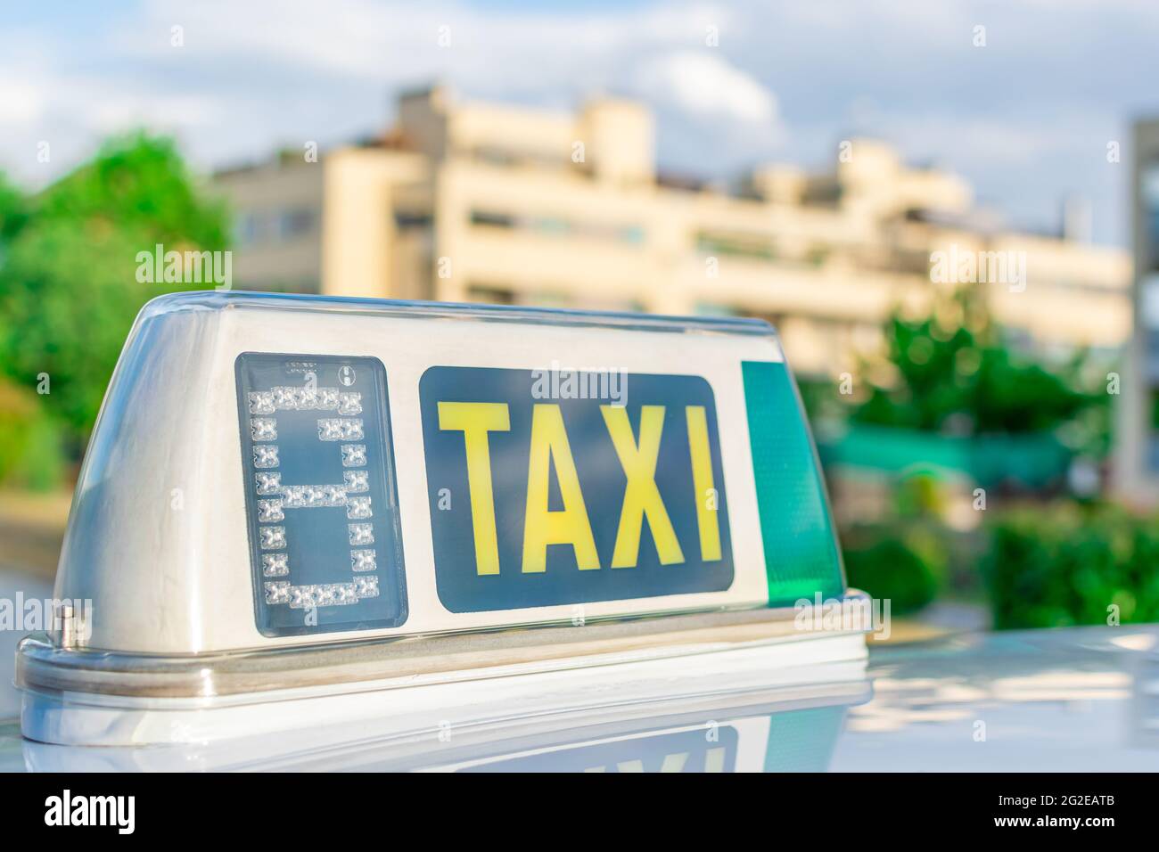 Of illuminated cab sign in front of a block of buildings in the ...