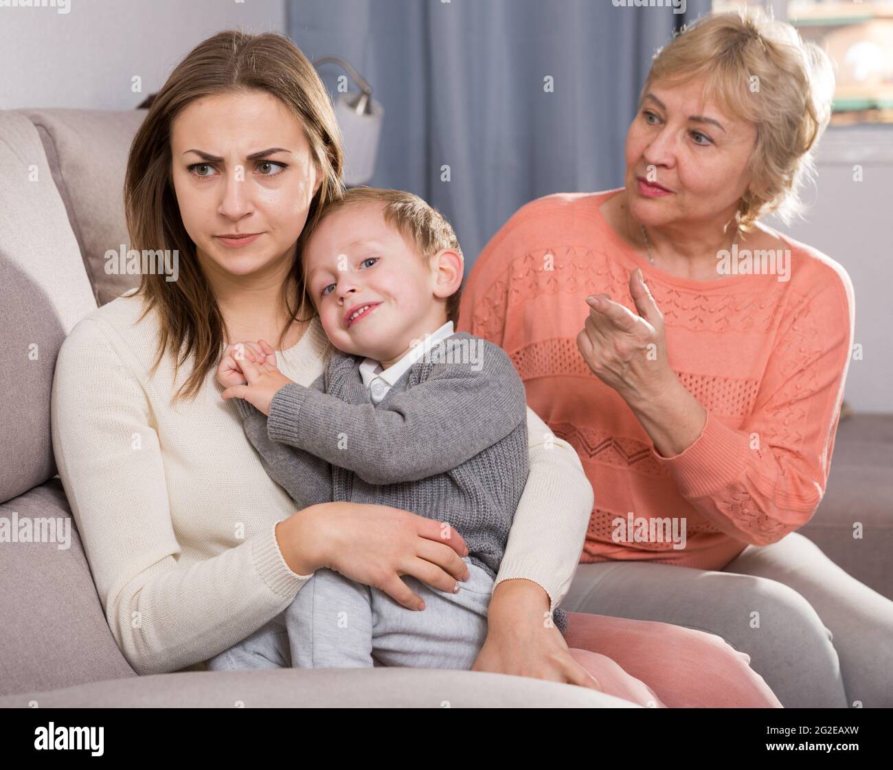 Two women are quarreling for upbringing toddler Stock Photo - Alamy