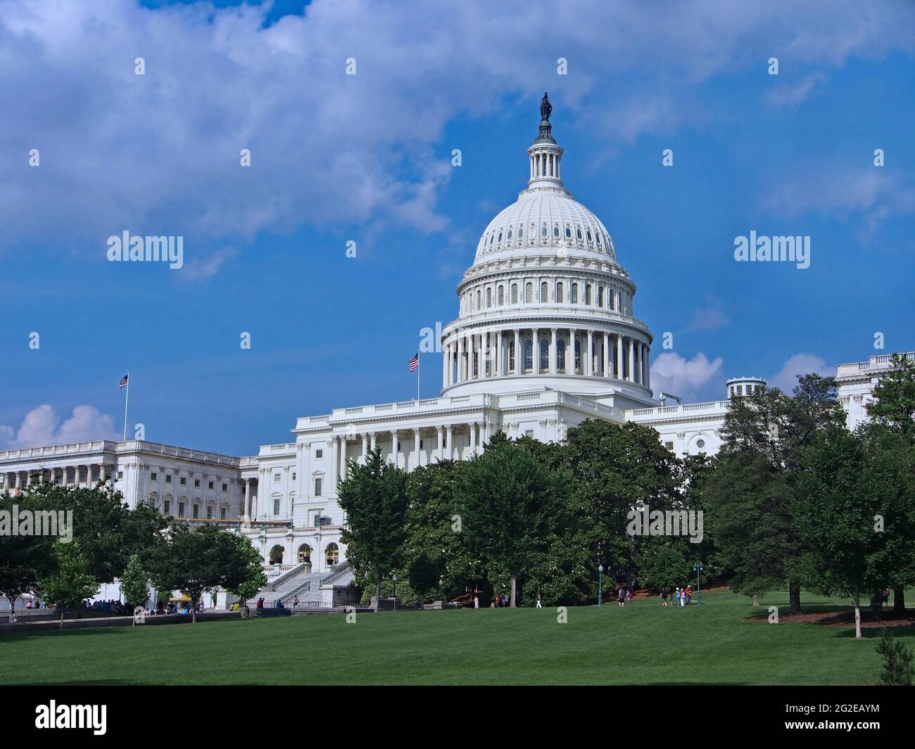 Visitors walking on the rear lawn of the United States Capitol Building ...