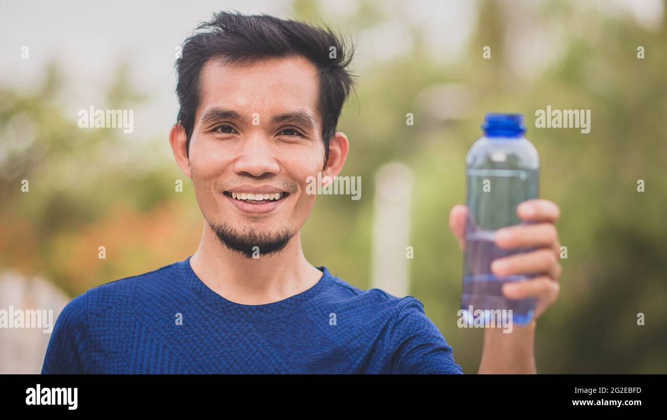 Runner drinking water after running Stock Photo - Alamy