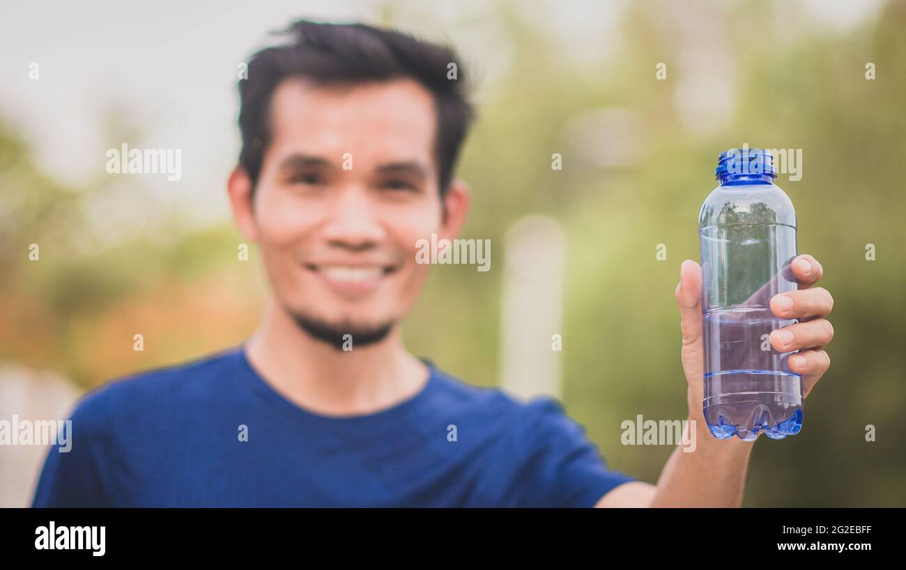 Happy male runner drinking hi-res stock photography and images - Alamy