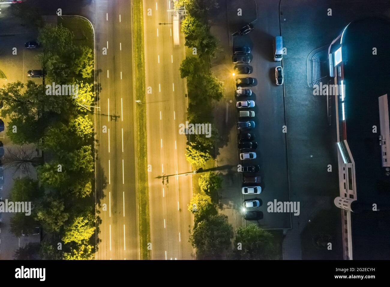 aerial top view of parking lot near illuminated street. aerial drone ...