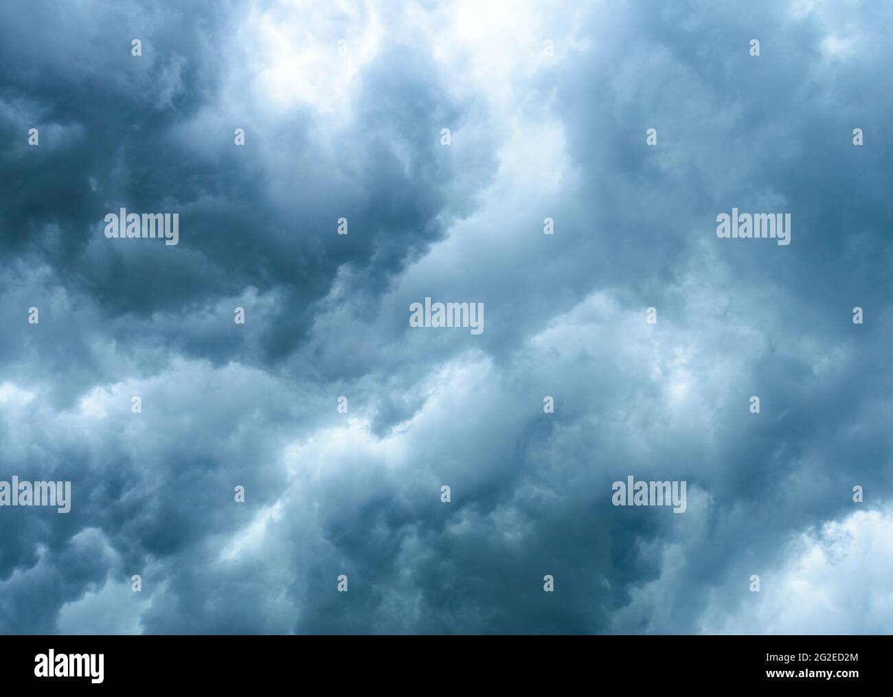 Thick dark black storm clouds covering summer sunset sky with gale ...