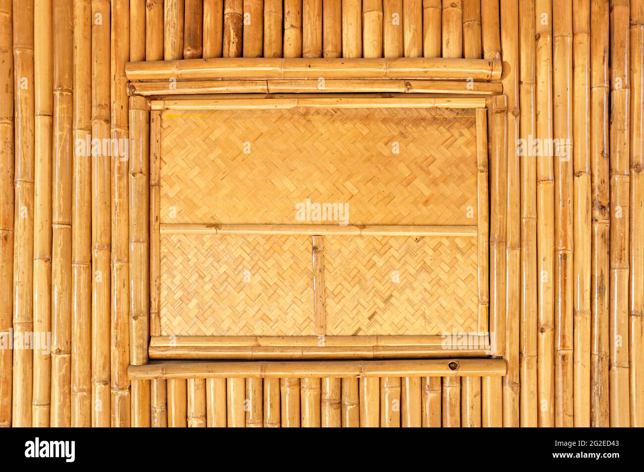 Woven window panel on bamboo wall Stock Photo - Alamy