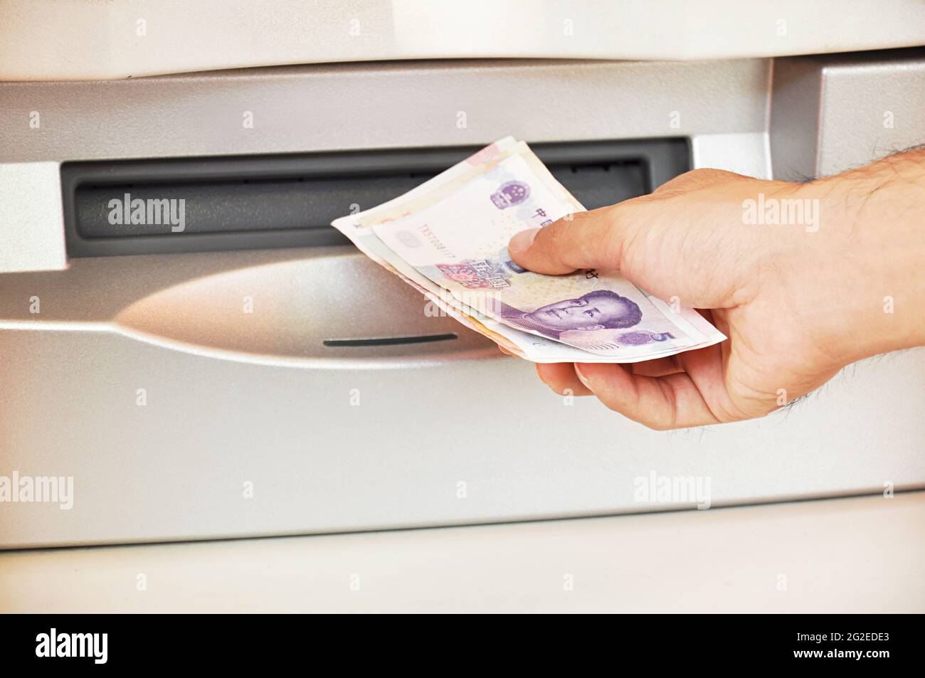 Hand taking money from ATM Stock Photo - Alamy