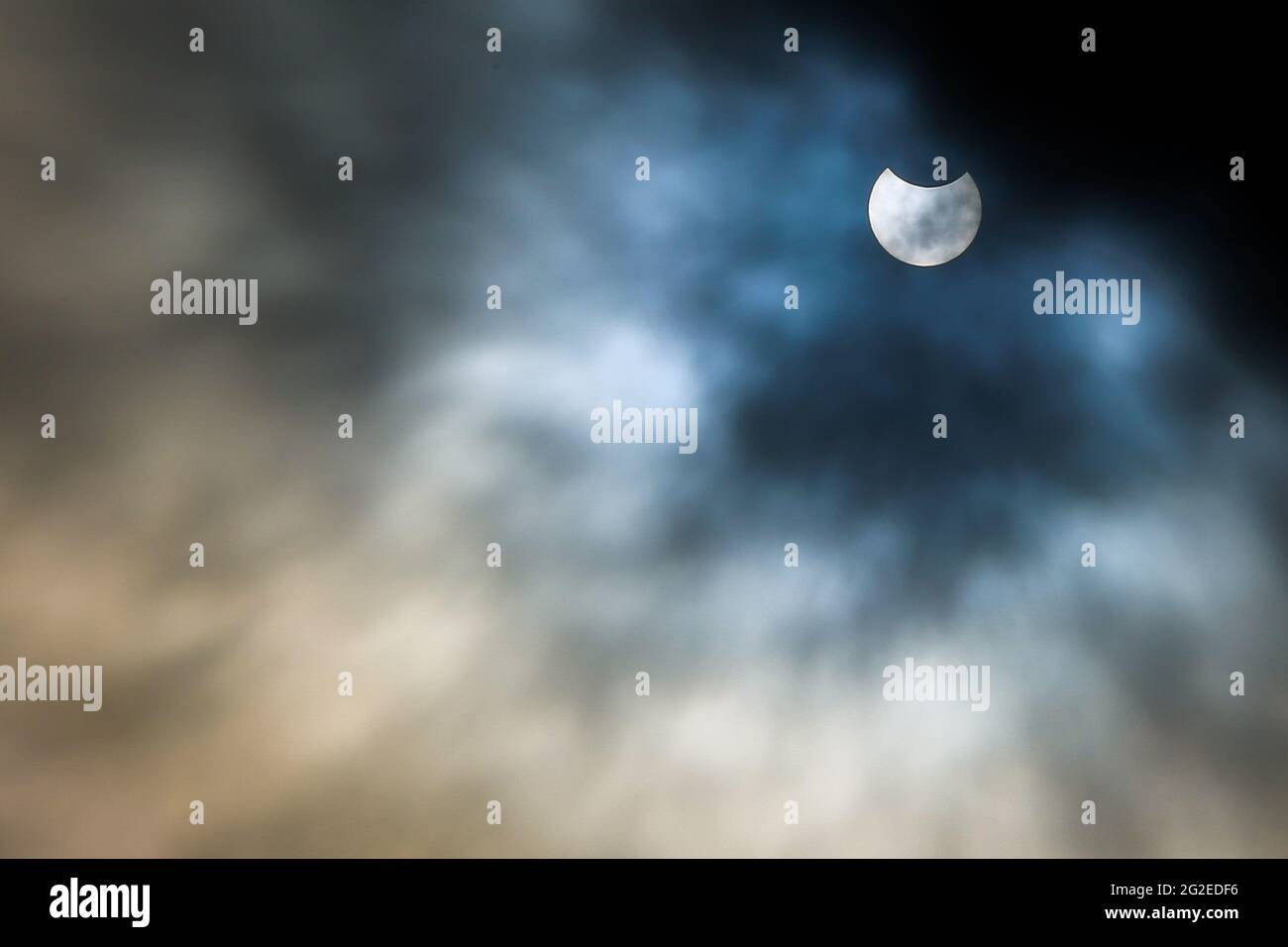 London, UK. 10th June, 2021. Partial Solar Eclipse seen over London as ...