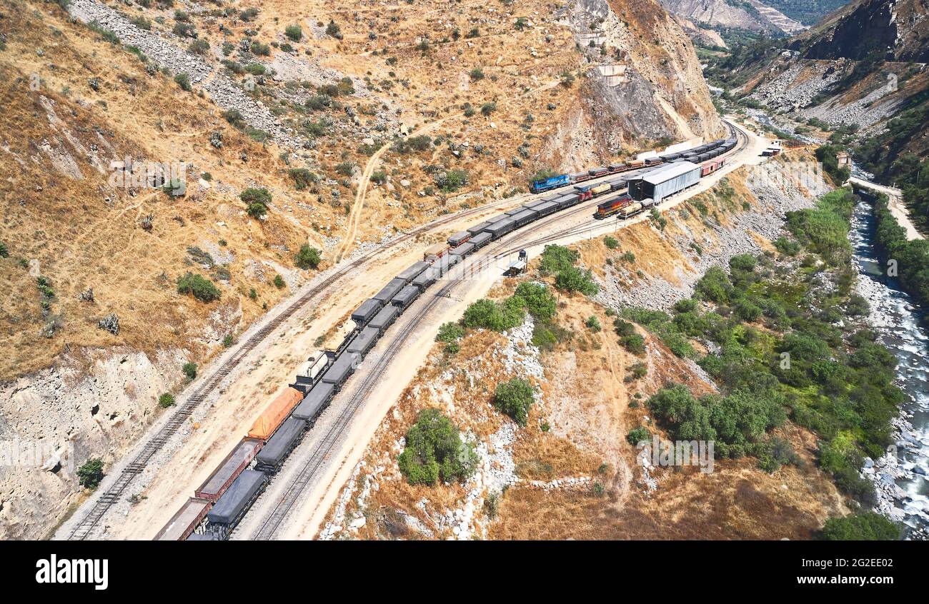 Aerial view of several railway wagon trains with goods at the railway ...