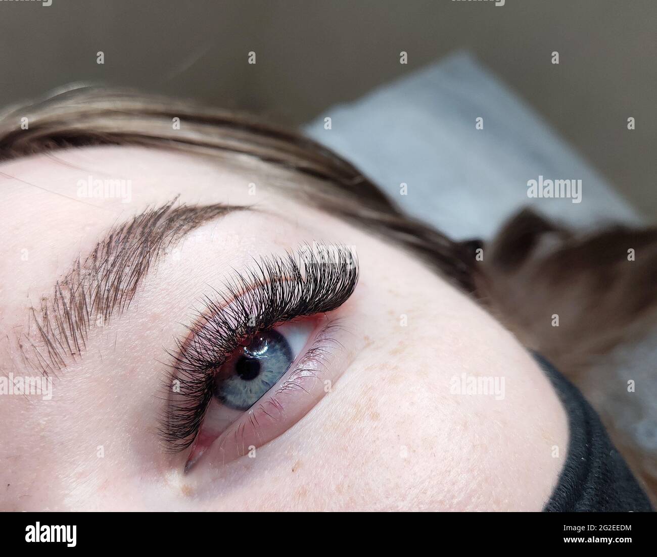 Lash extensions macro blue eye top view Stock Photo - Alamy