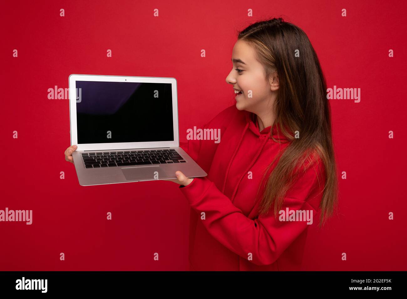 Side profile photo of beautiful happy girl with long hair wearing red ...