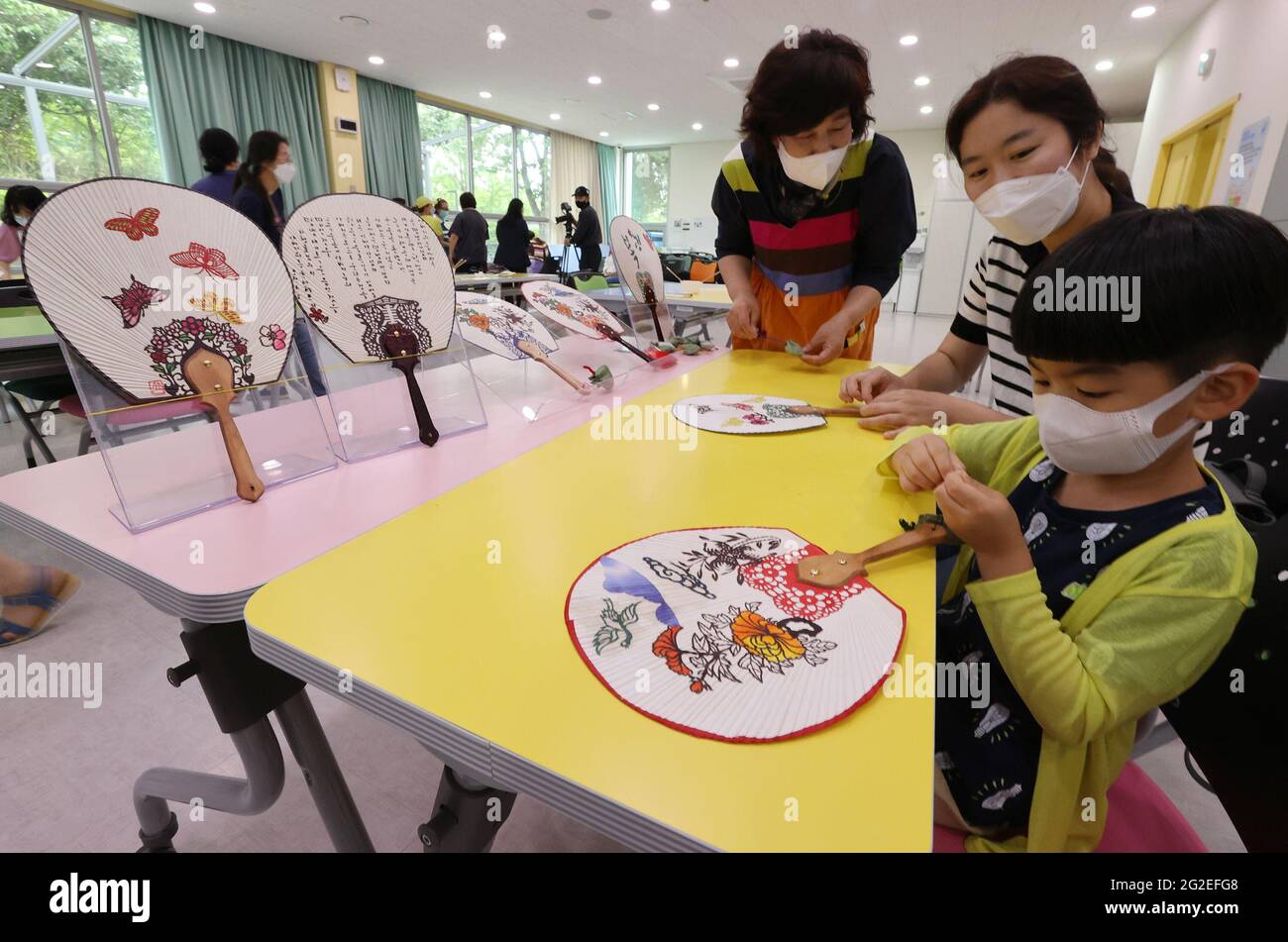 11th June, 2021. Making traditional Korean fans A kid makes a ...