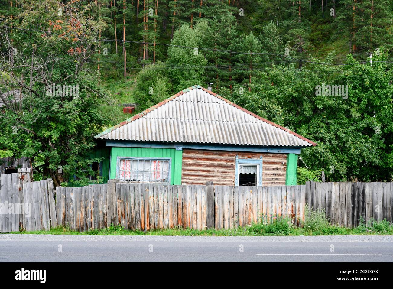 Leaning wooden house by the road Stock Photo - Alamy