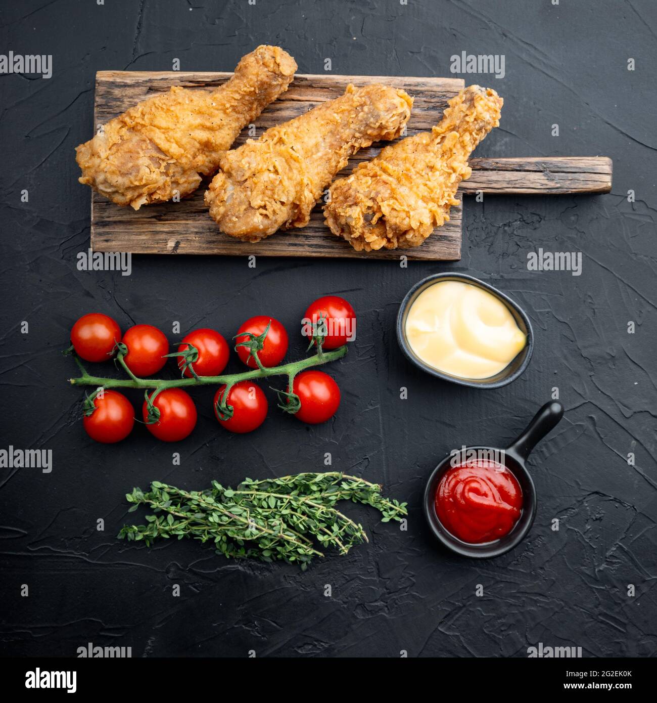Crispy fried chicken cuts on black background, top view Stock Photo - Alamy
