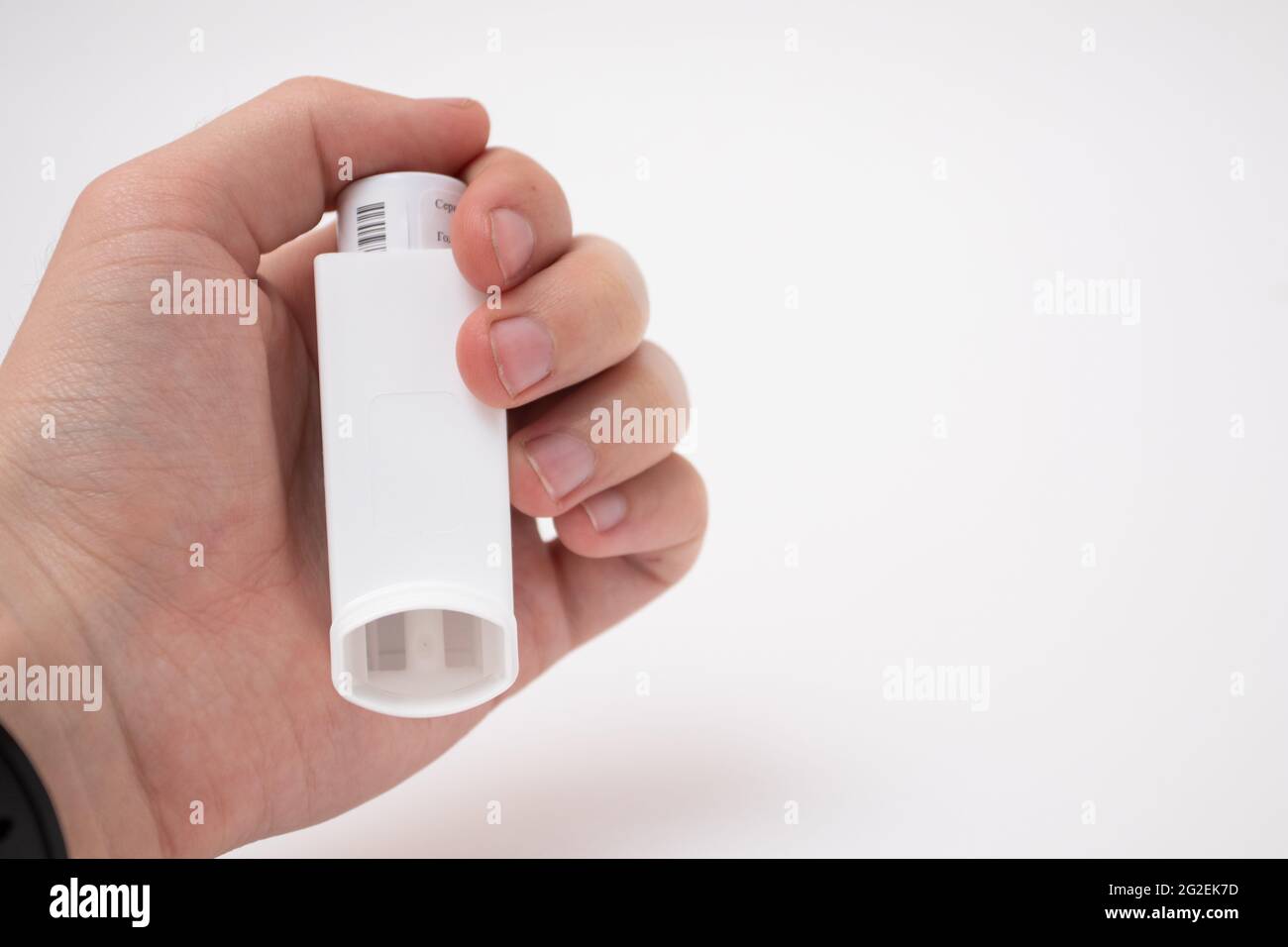 Hand holding asthma inhaler on white background Stock Photo - Alamy