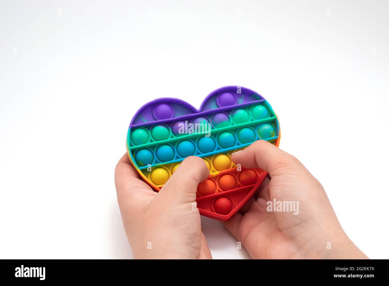 Kid playing pop it game. Children's hands playing with a rubber simple ...