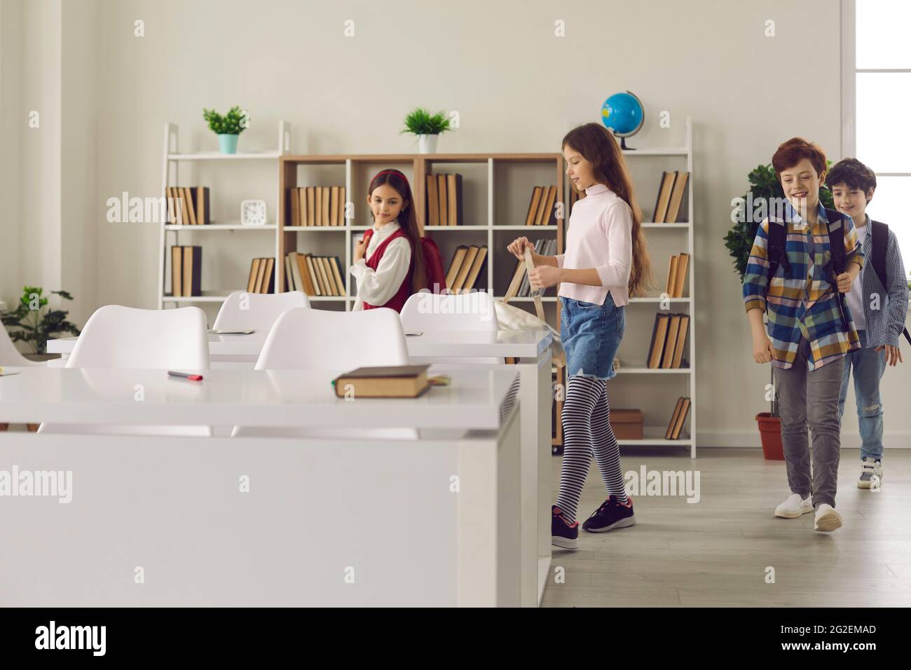 Elementary children entering classroom after a noon recess between ...
