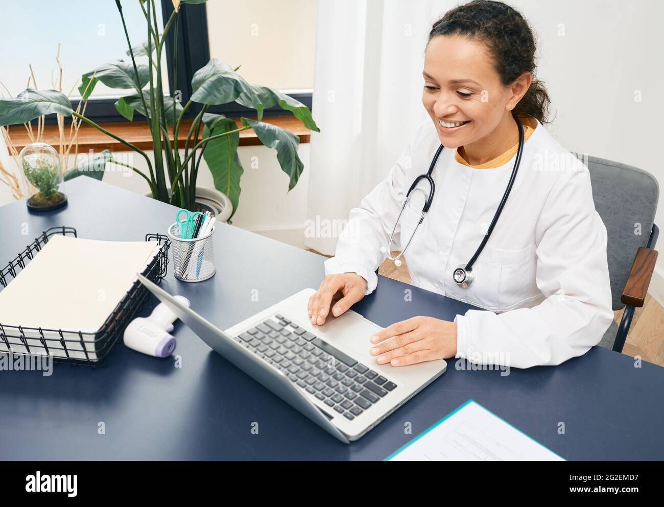 Beautiful female doctor during an online internet consultation remotely ...
