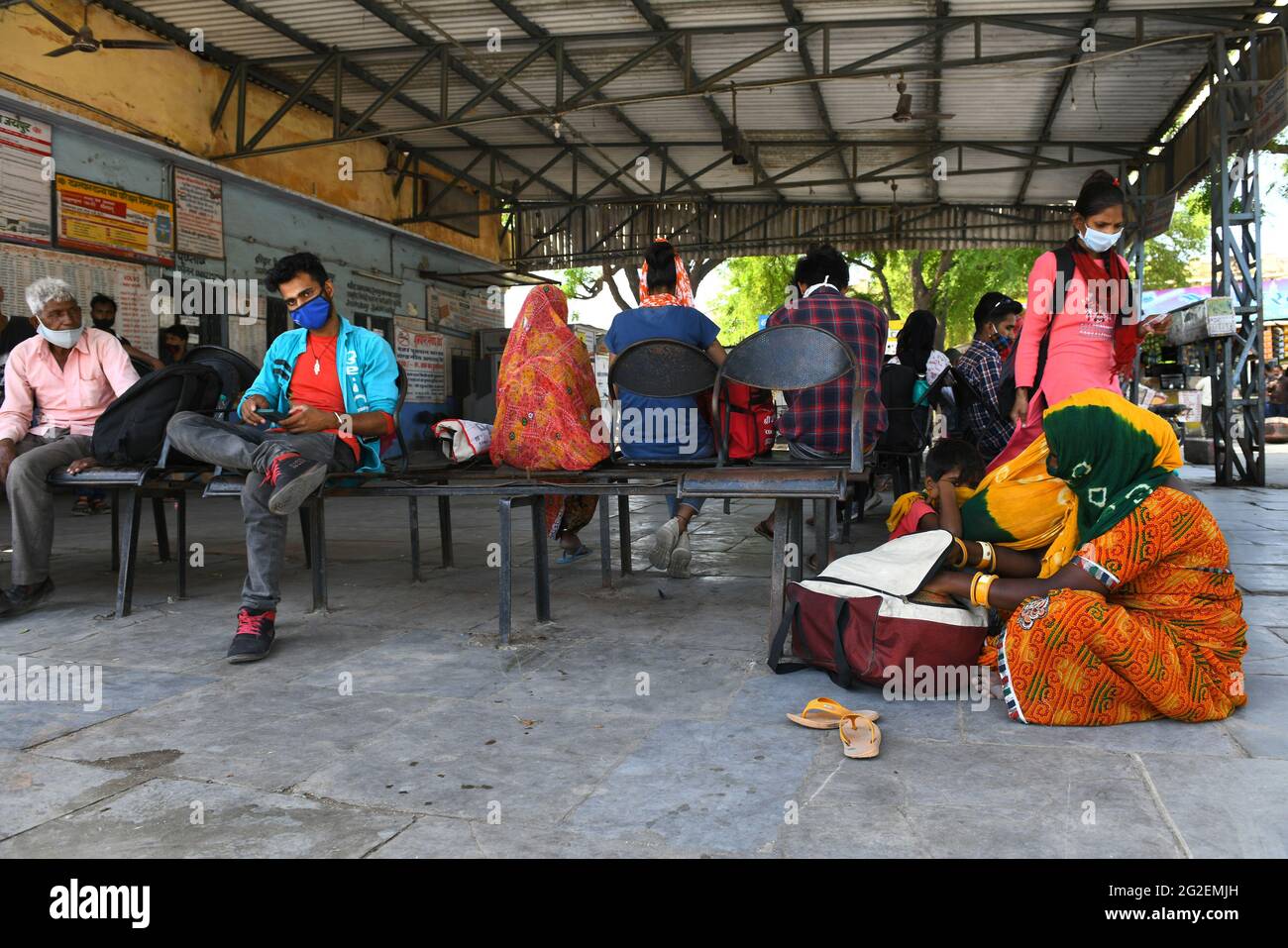 Beawar, India. 10th June, 2021. Passengers wait to board buses for ...