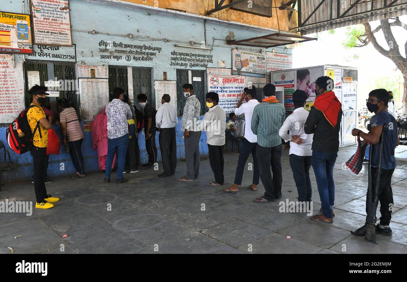 Beawar, India. 10th June, 2021. Passengers stand in a queue at a ticket ...