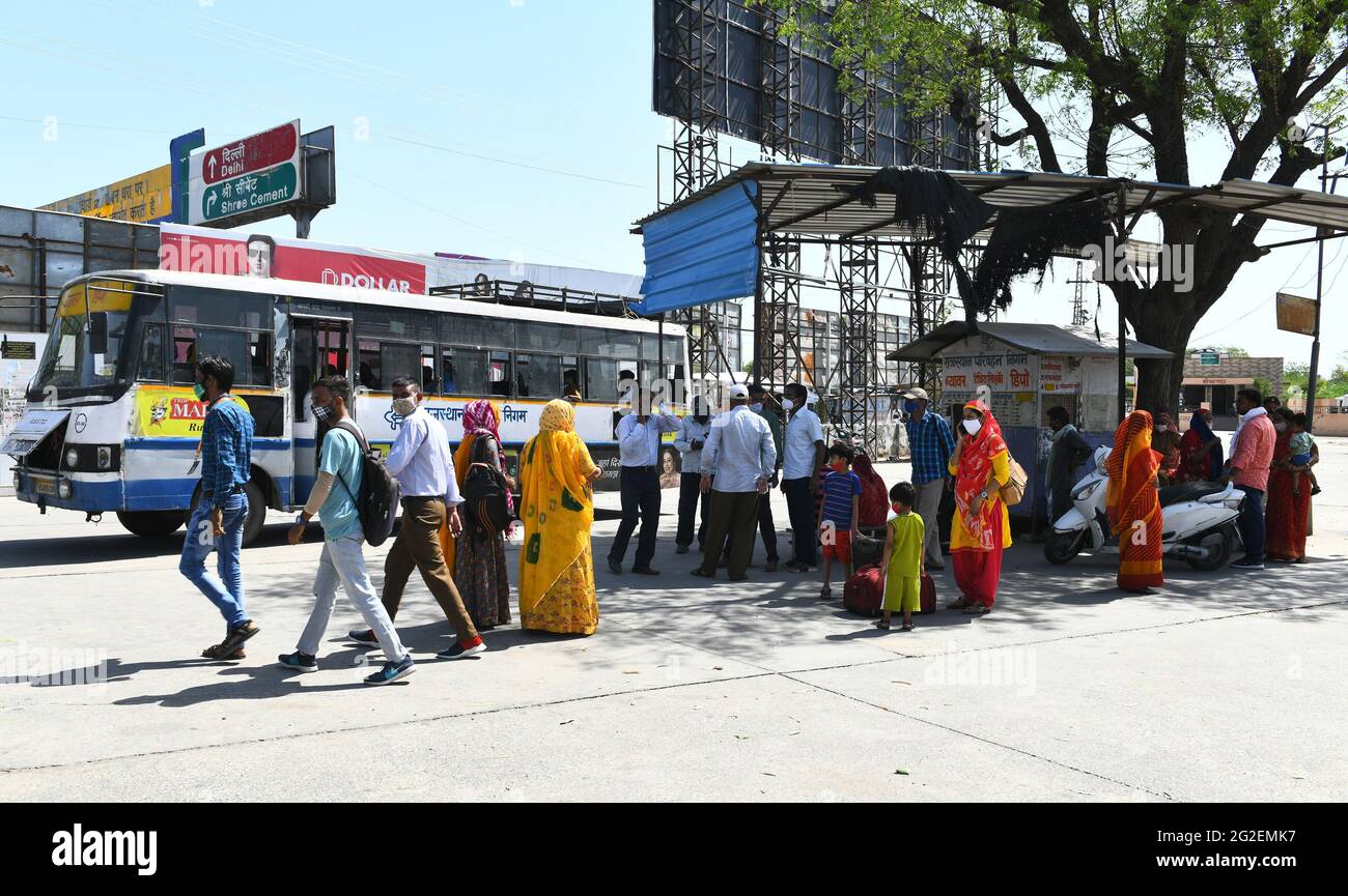 Beawar, India. 10th June, 2021. Passengers wait to board buses for ...
