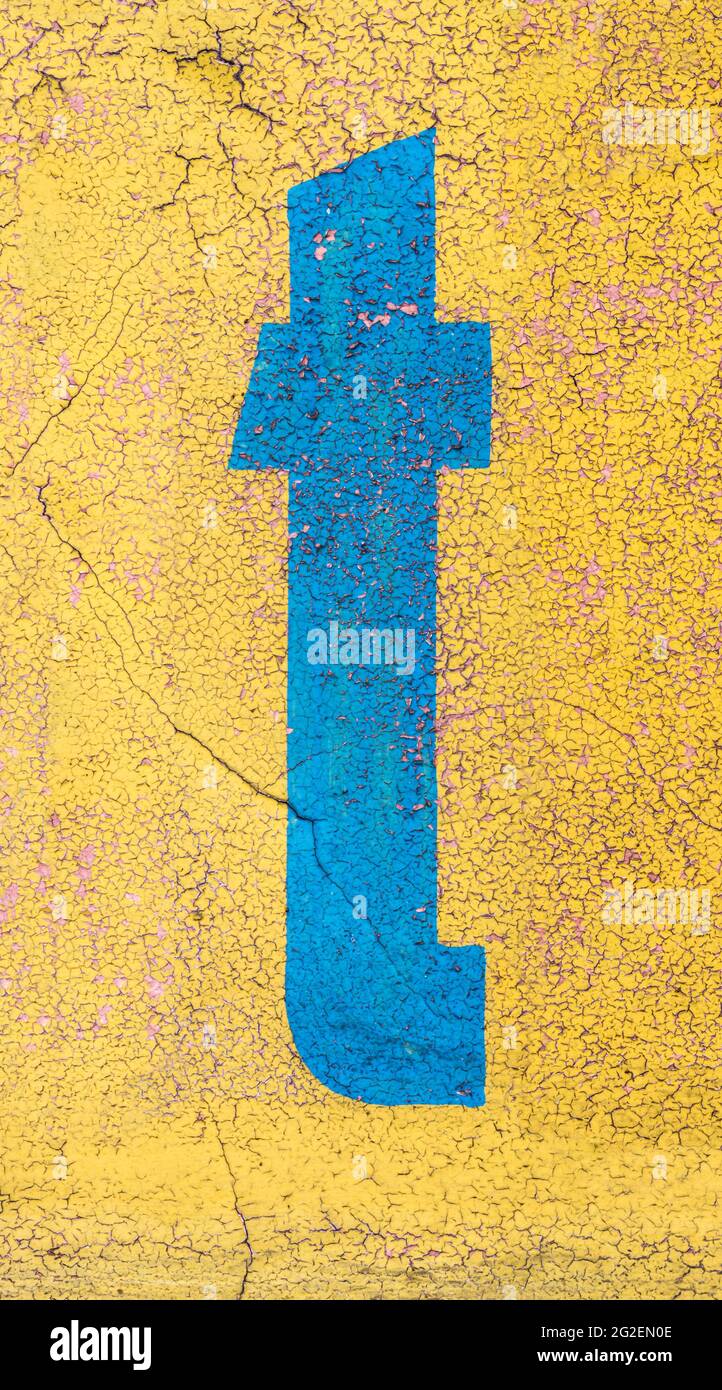 Cyan blue letter t painted on yellow wall Stock Photo - Alamy