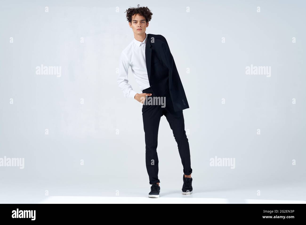 man with a jacket in his hands in full growth posing fashion self ...