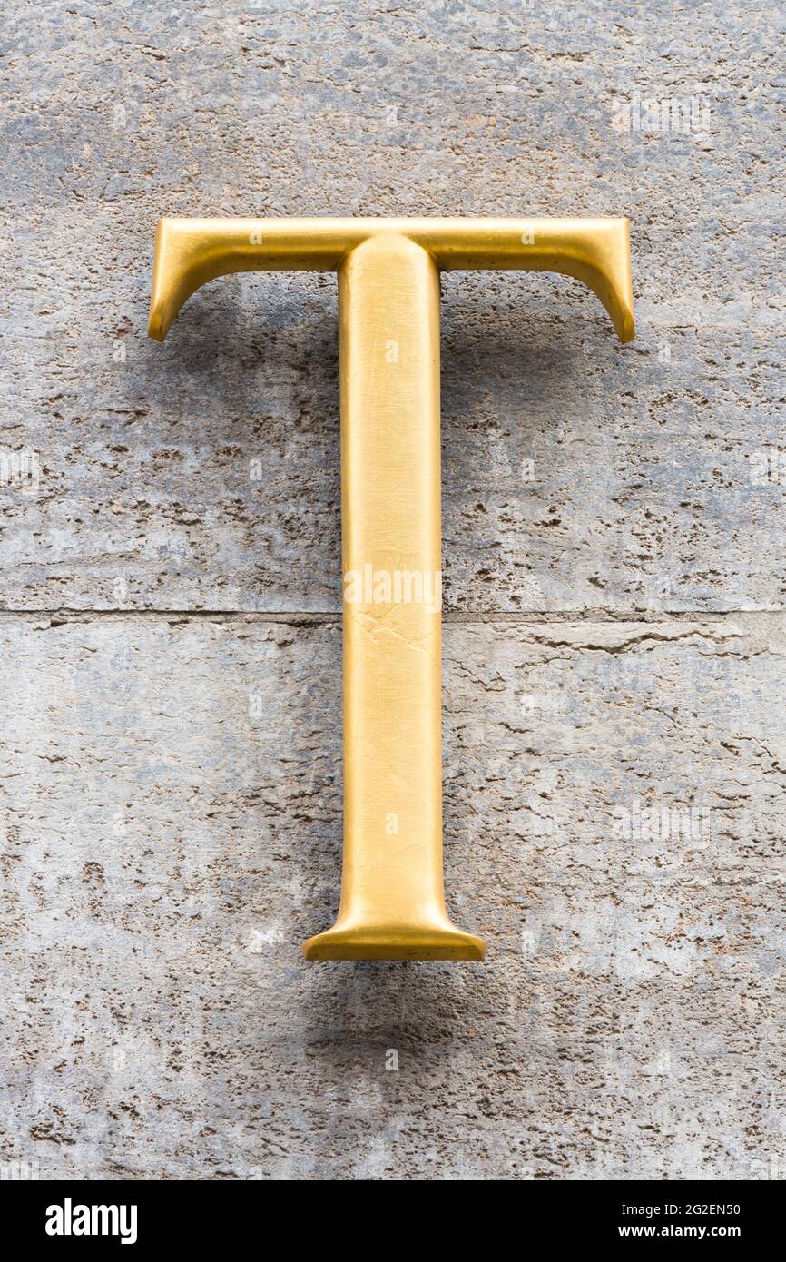 Golden letter T with clear serifs Stock Photo - Alamy