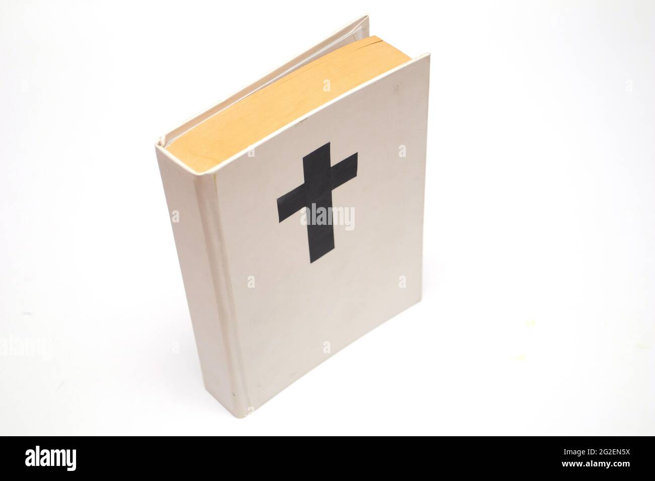White book with a cross on the cover Stock Photo - Alamy