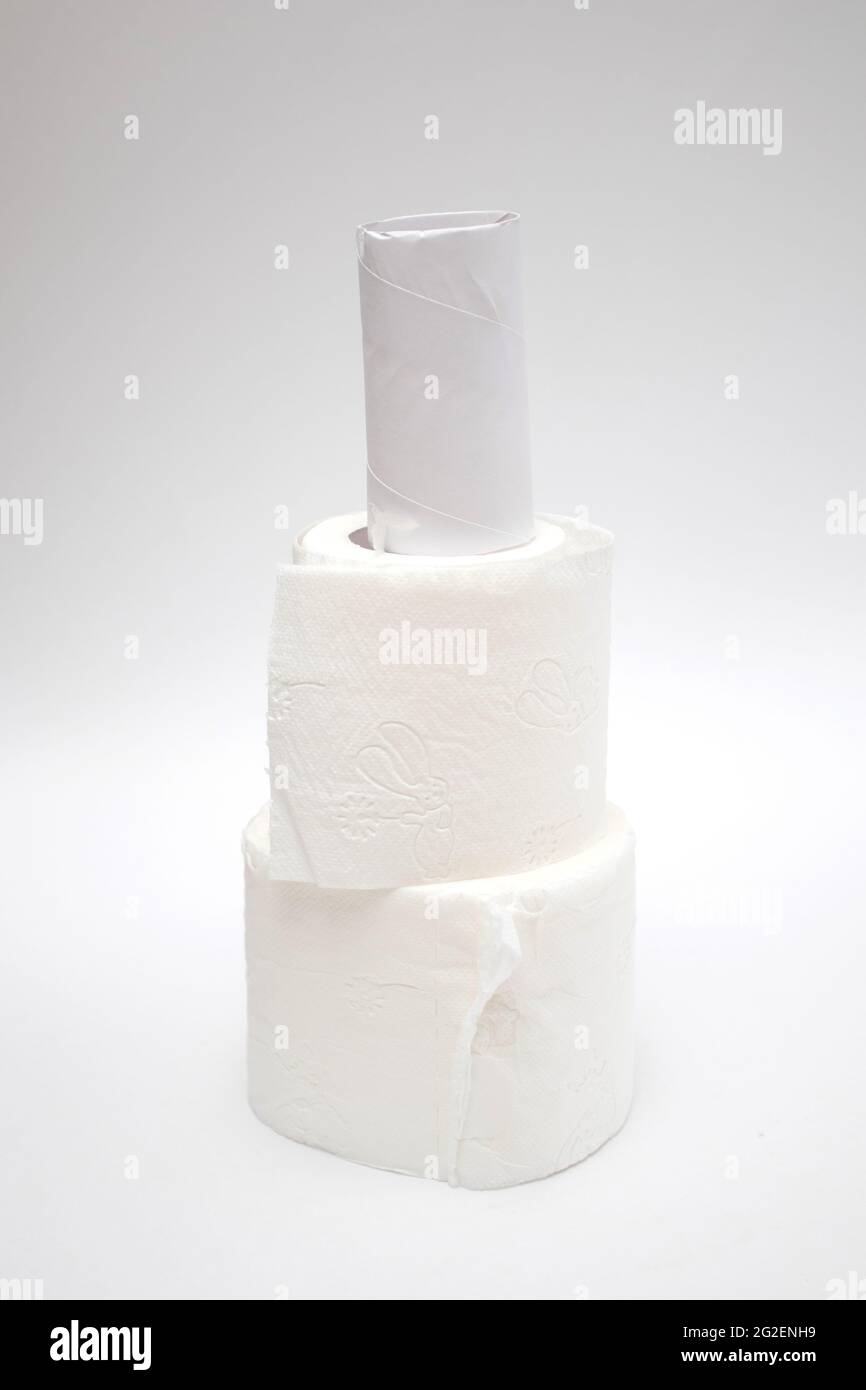 A stack of toilet paper rolls on white background Stock Photo - Alamy