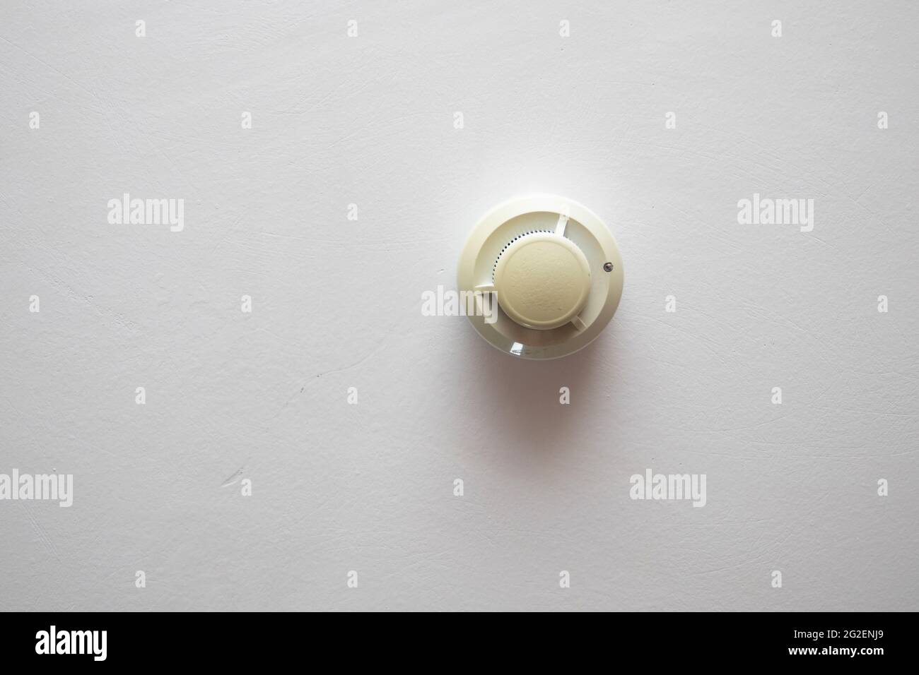 Smoke detector on the ceiling. Alarm security system hanging on ceiling ...