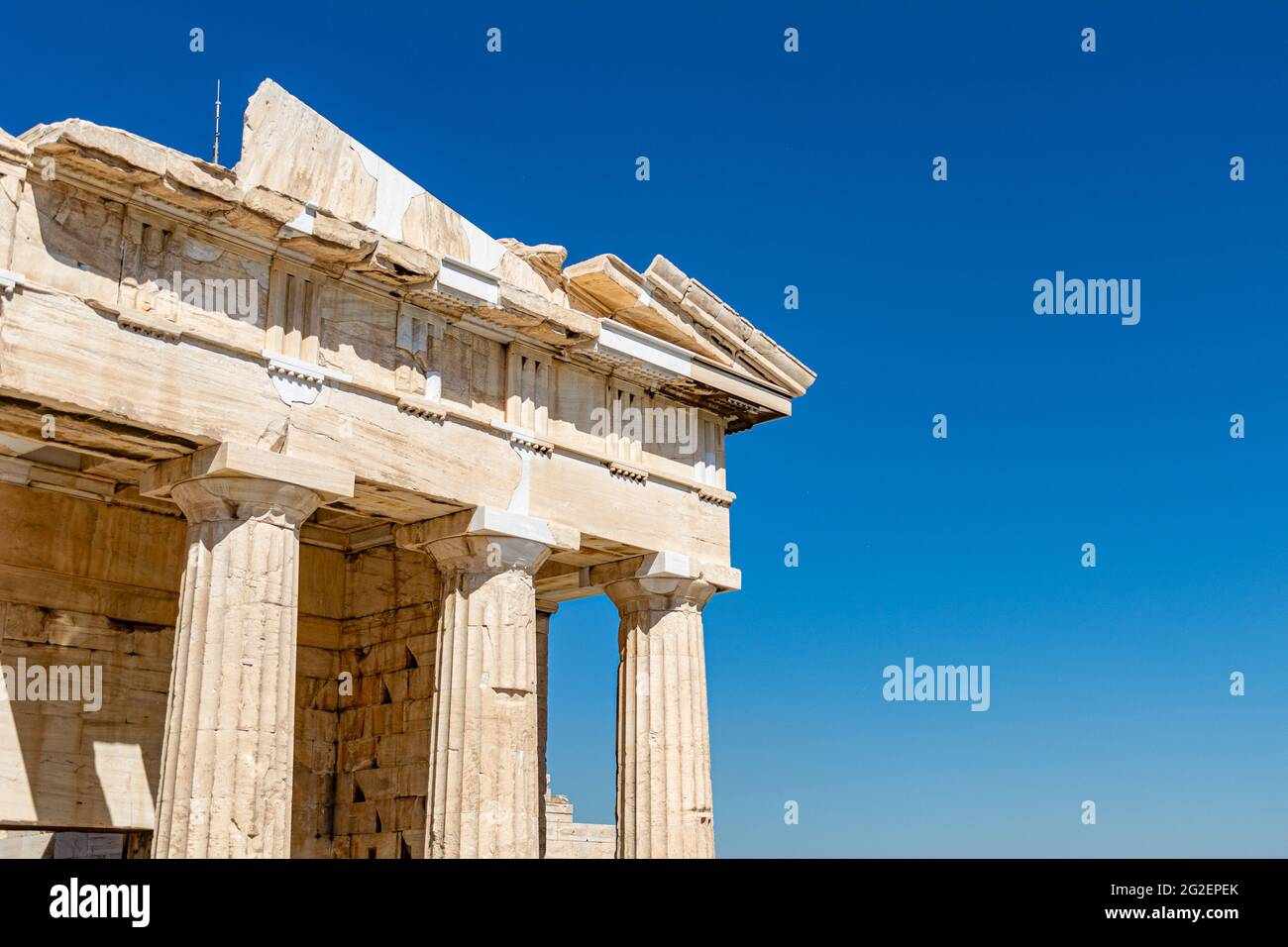 Close up of columns and the roof of the Parthenon Temple with blue sky ...