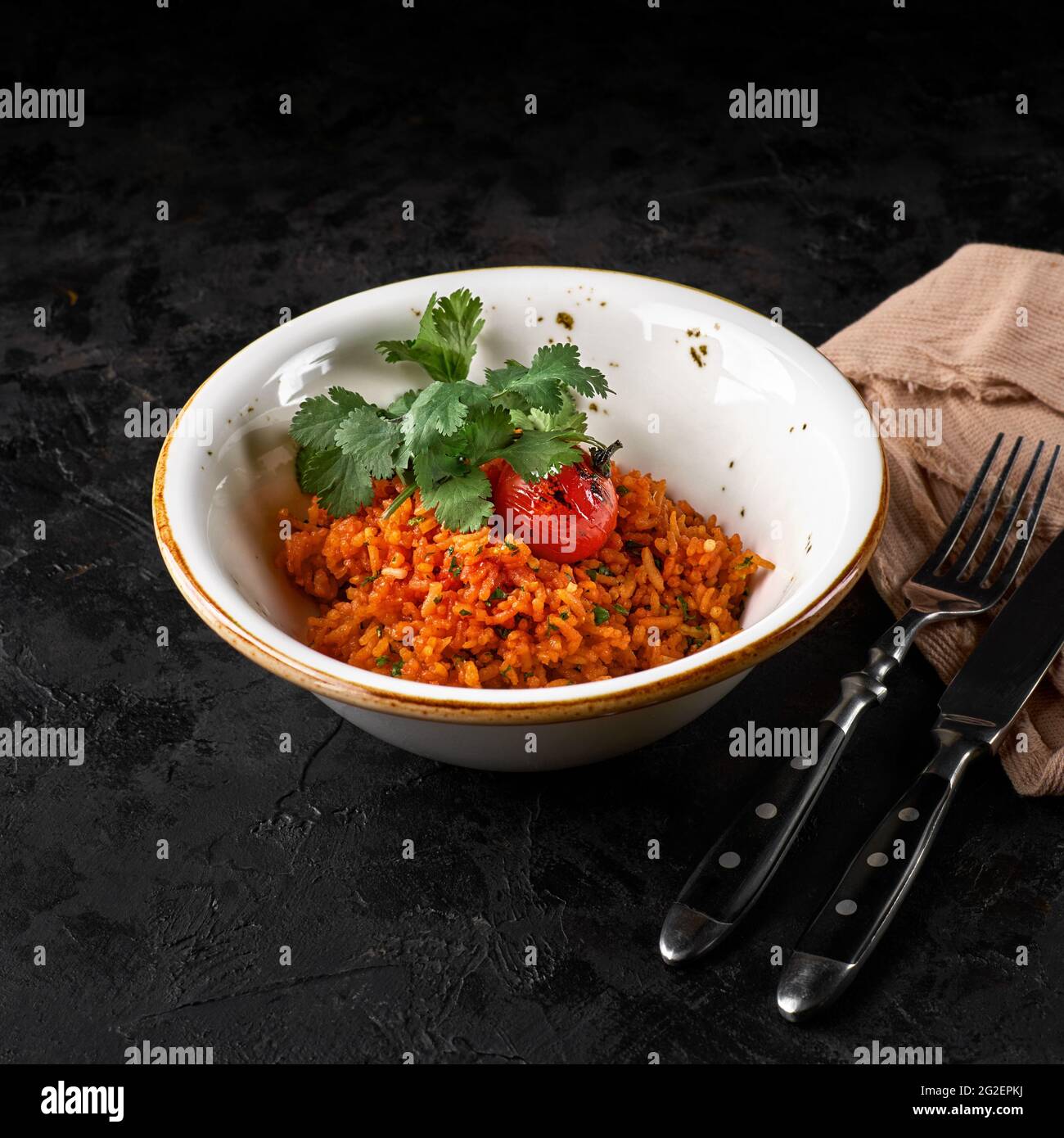 Basmati rice with turmeric and herbs. on plate on black slate ...