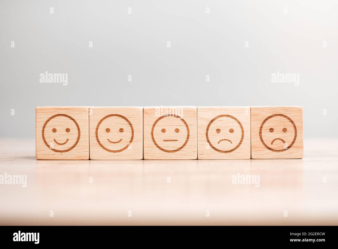 emotion face symbol on wooden blocks. Service rating, ranking, customer ...