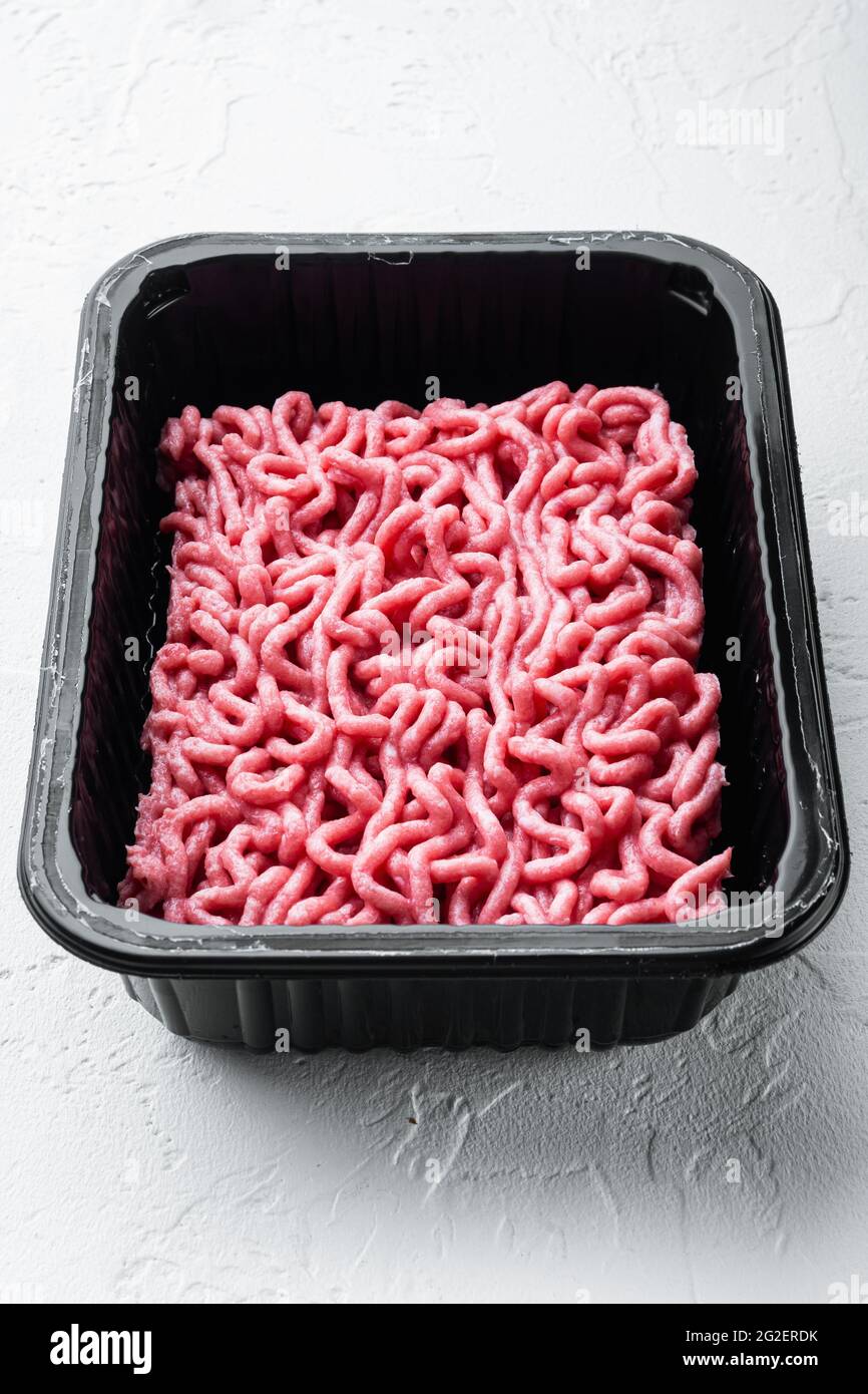 Ground beef meat in plastic tray set, on white stone background Stock ...