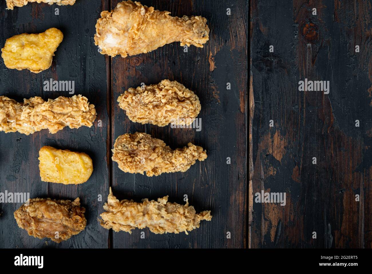 Crispy kentucky fried chicken cuts on dark wooden background, top view ...