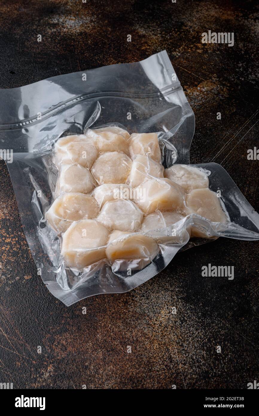 Scallops, in vacuum pack, on old rustic background Stock Photo - Alamy