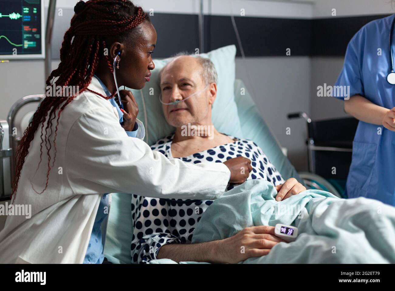African american cardiologist checking examining senior patient heart ...