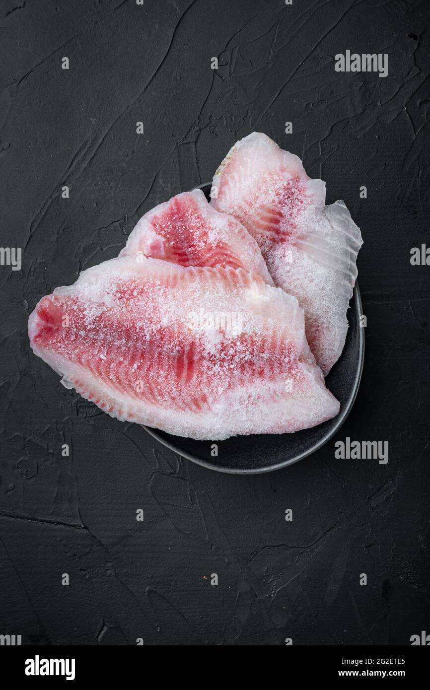 Frozen, white fish fillet, on black background, top view Stock Photo ...
