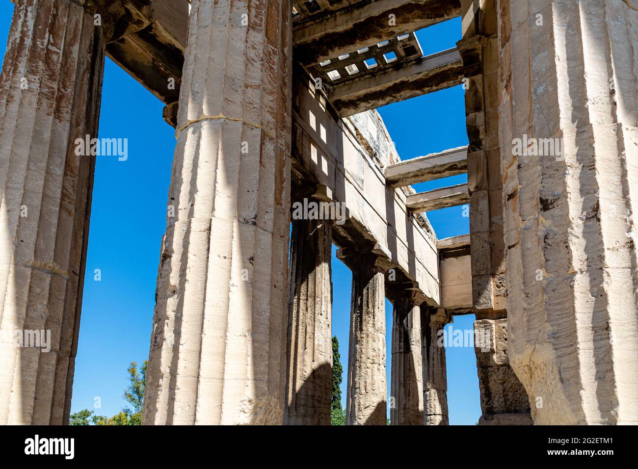 The portico of Temple of Hephaestus with ancient columns against a blue ...