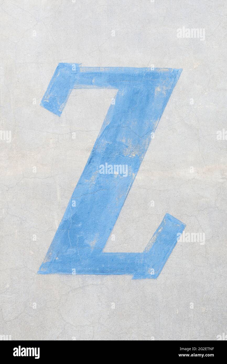 Light blue letter Z in serif font on a light grey wall Stock Photo - Alamy