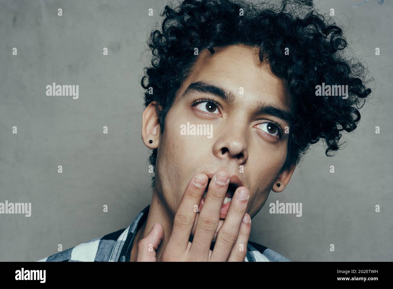 cute guy portrait curly hair emotions gray background model Stock Photo ...