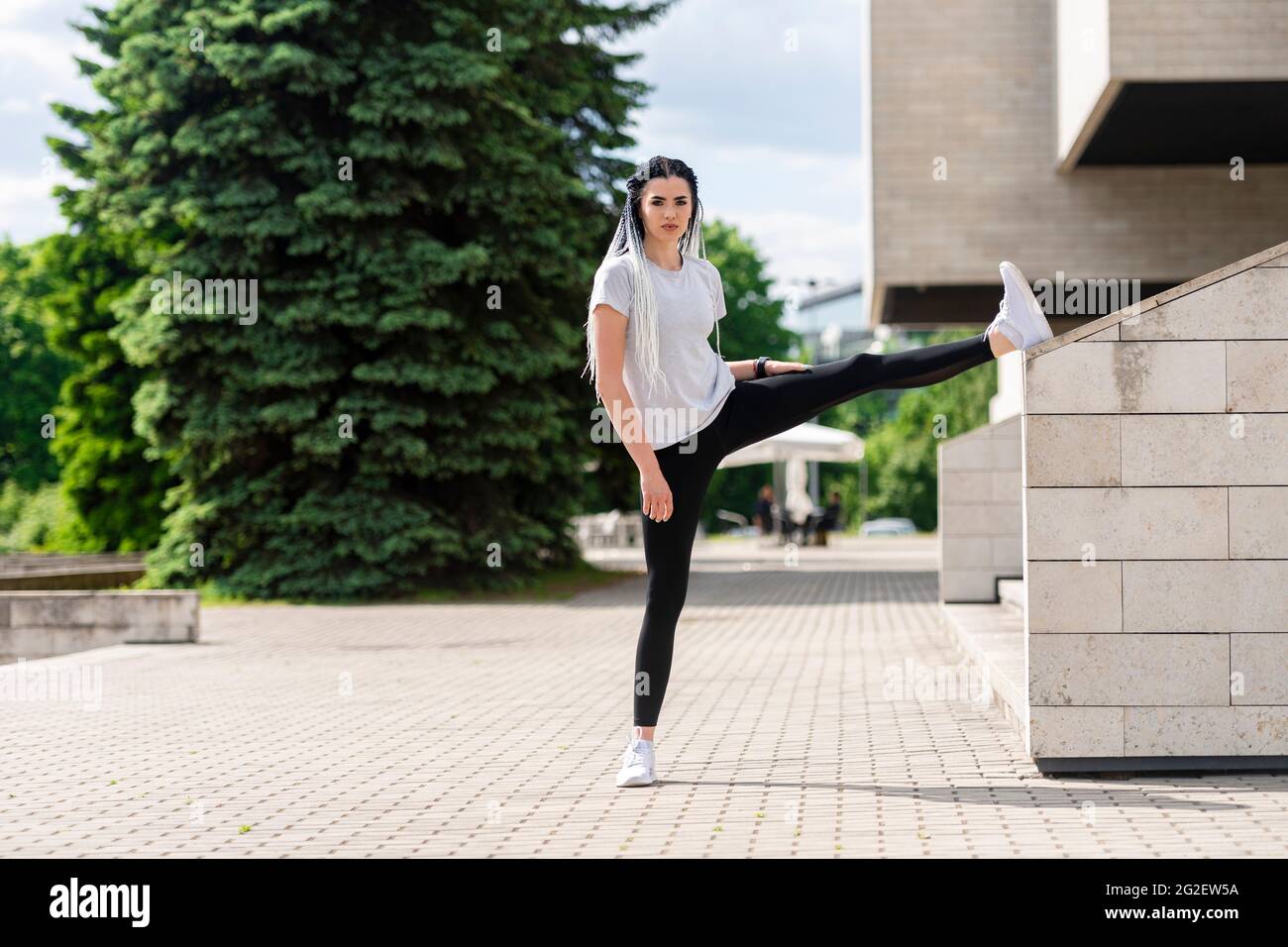 Fitness sport woman with african braids doing stretching exercise in ...