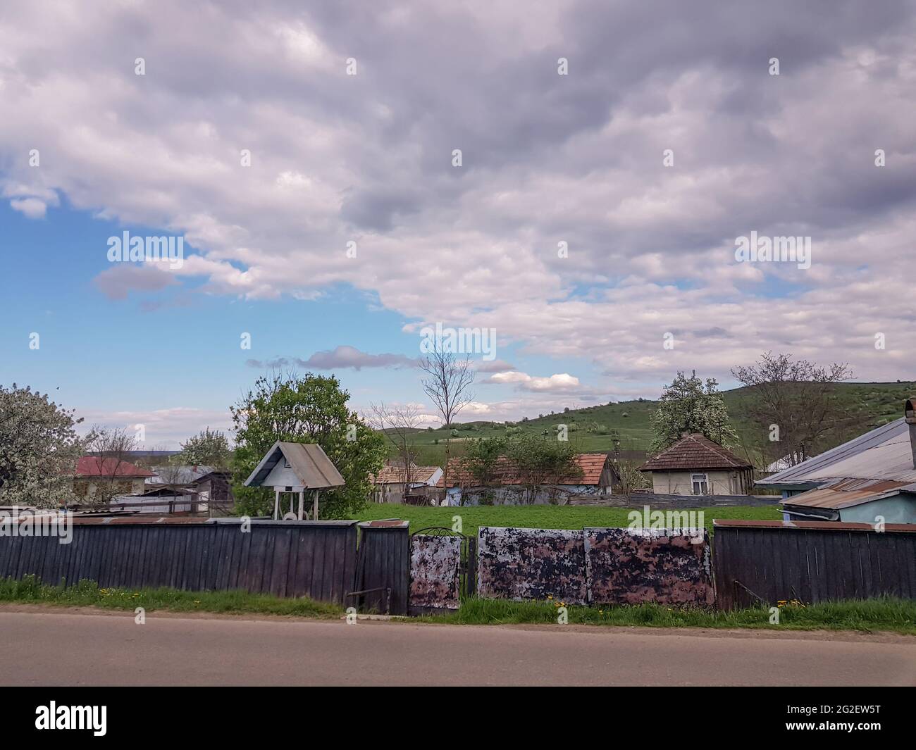 Rural scene with small village houses behind the fence Stock Photo - Alamy