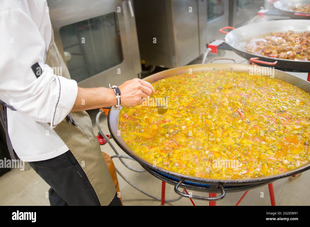 Paella in a big brazier being made by Spanish professionals Stock Photo ...
